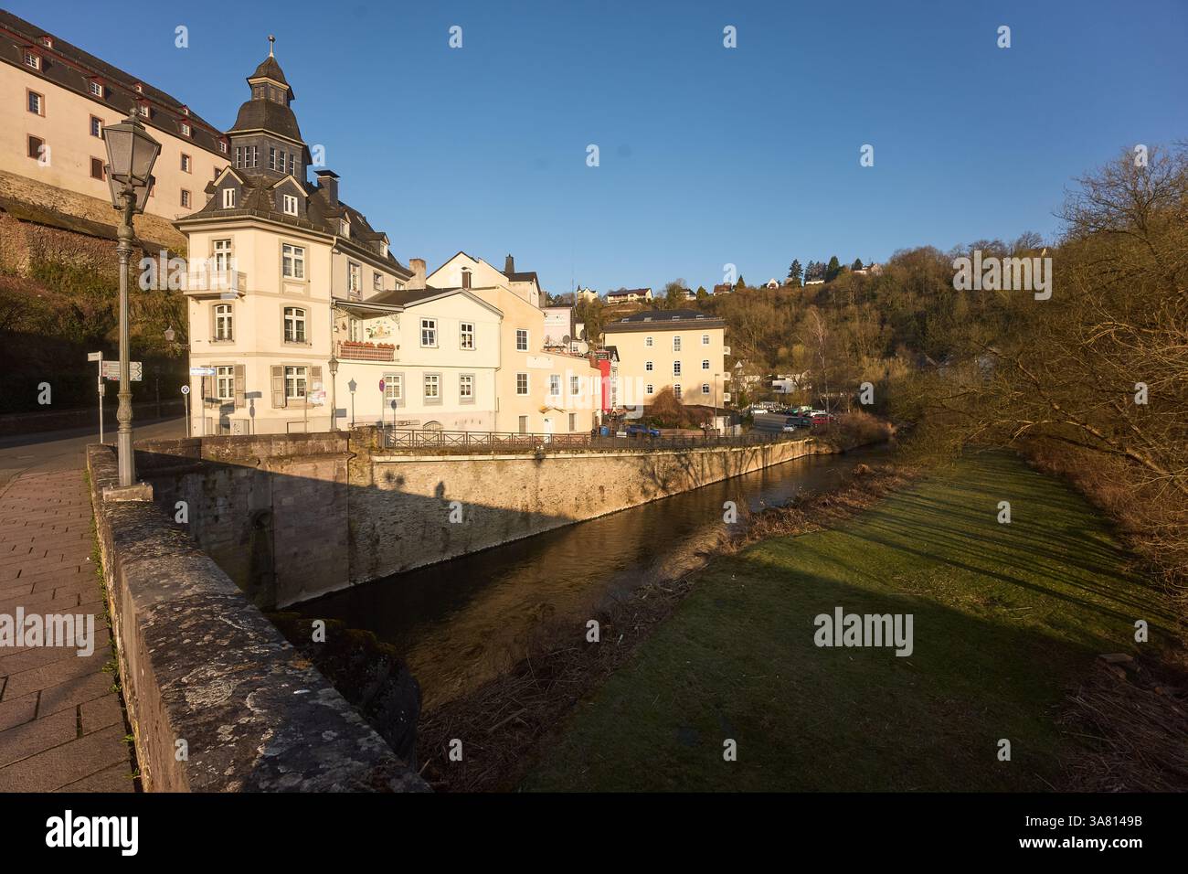 28 March 2025, Hesse, Weilburg: The Lahn flows past the old town of ...