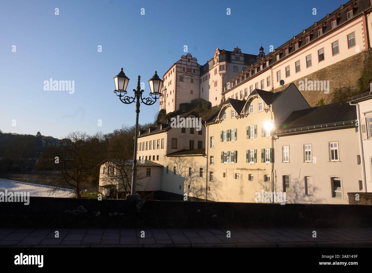 28 March 2025, Hesse, Weilburg: The Lahn flows past the old town of ...