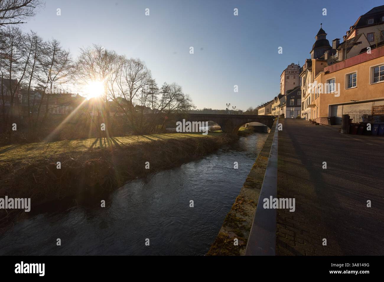 28 March 2025, Hesse, Weilburg: The Lahn flows past the old town of ...