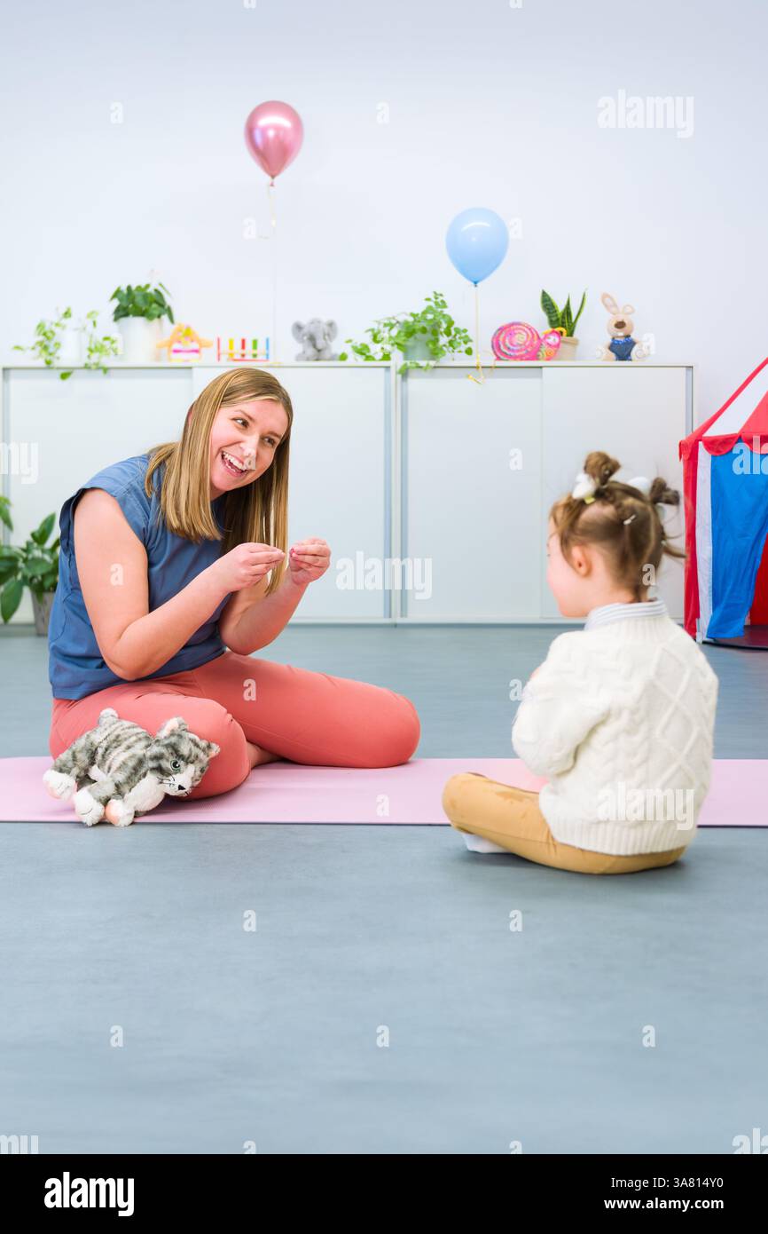 Baby Sign Language. Nonverbal child learning to sign with the help of a ...