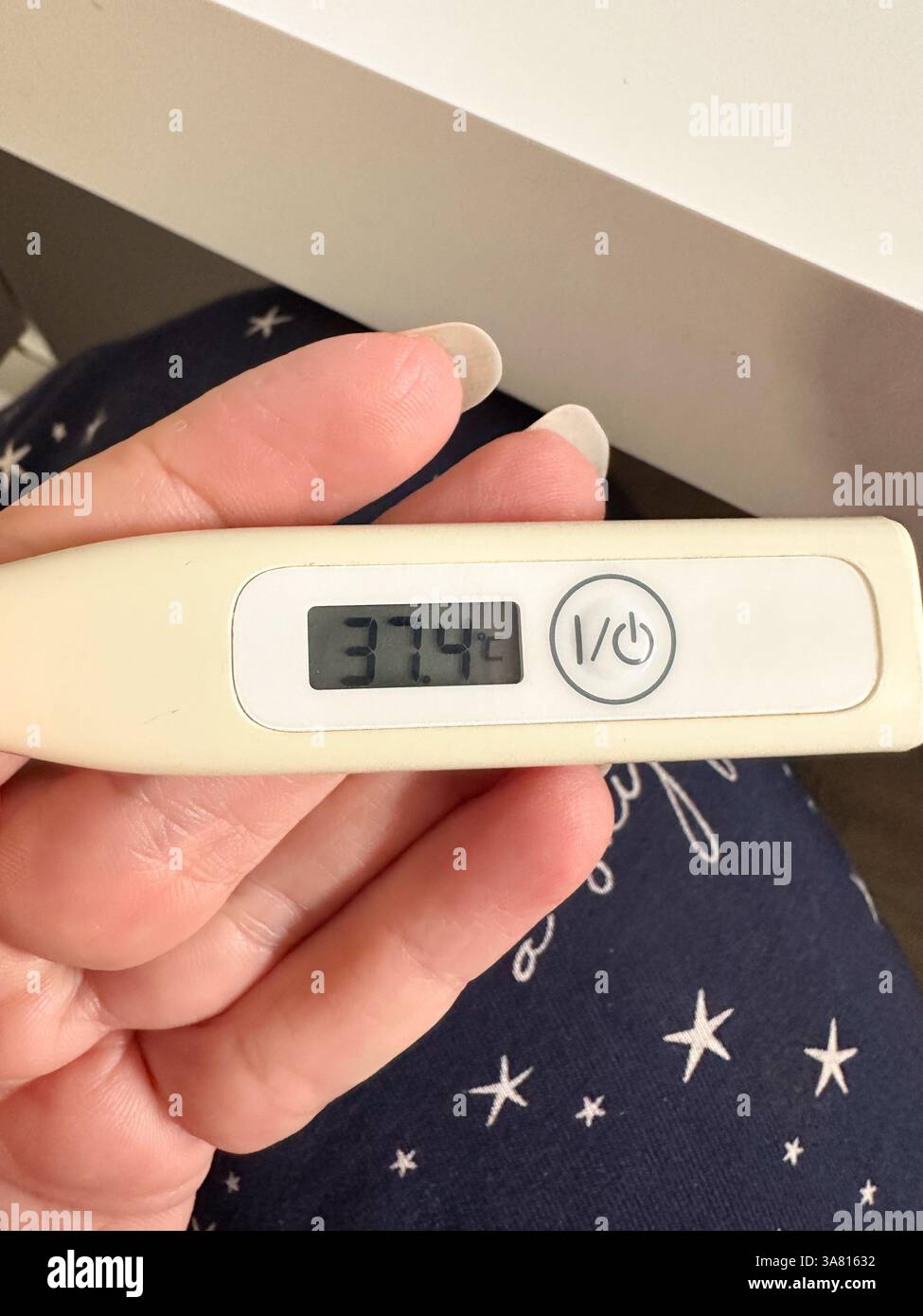 Digital thermometer showing body temperature in female hand during ...