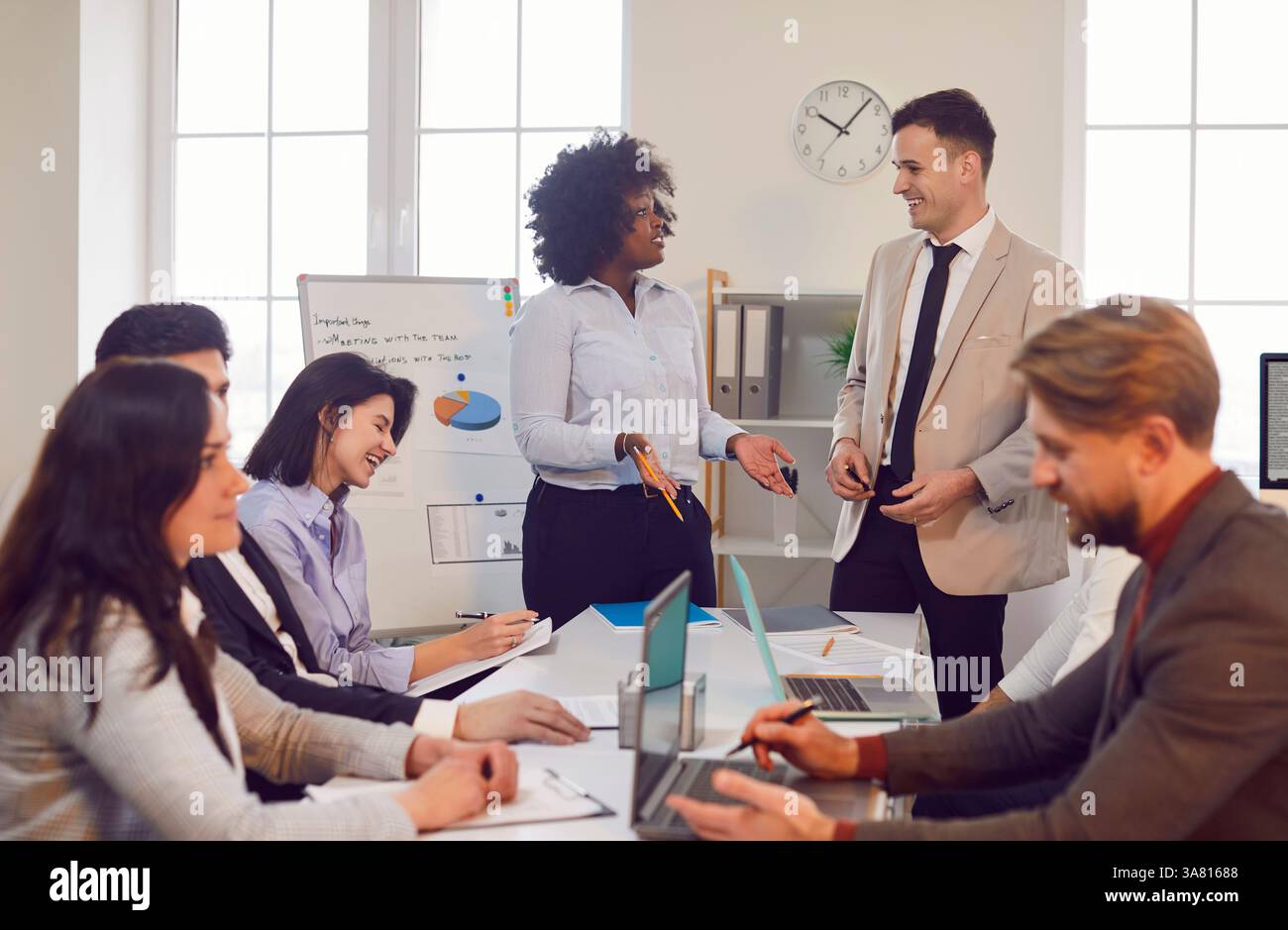 Business diverse people and coach speaker giving flipchart presentation ...