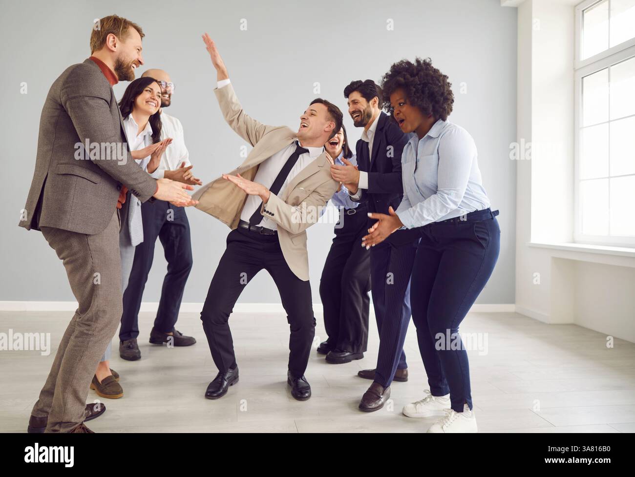 Man Dancing with Colleagues in Office Celebrating Success at Party ...