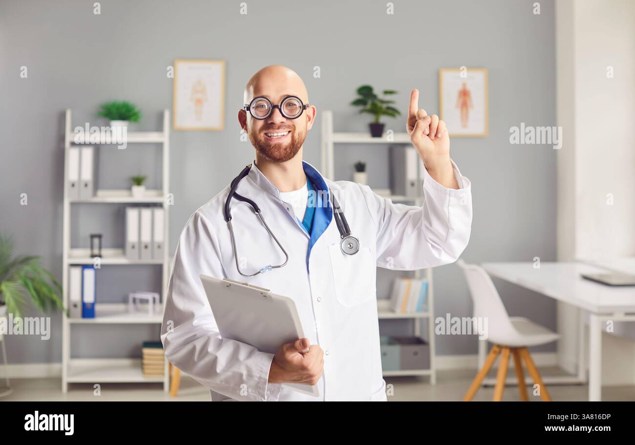 Portrait Of Funny Male Doctor Pointing Finger Up In Hospital Stock ...