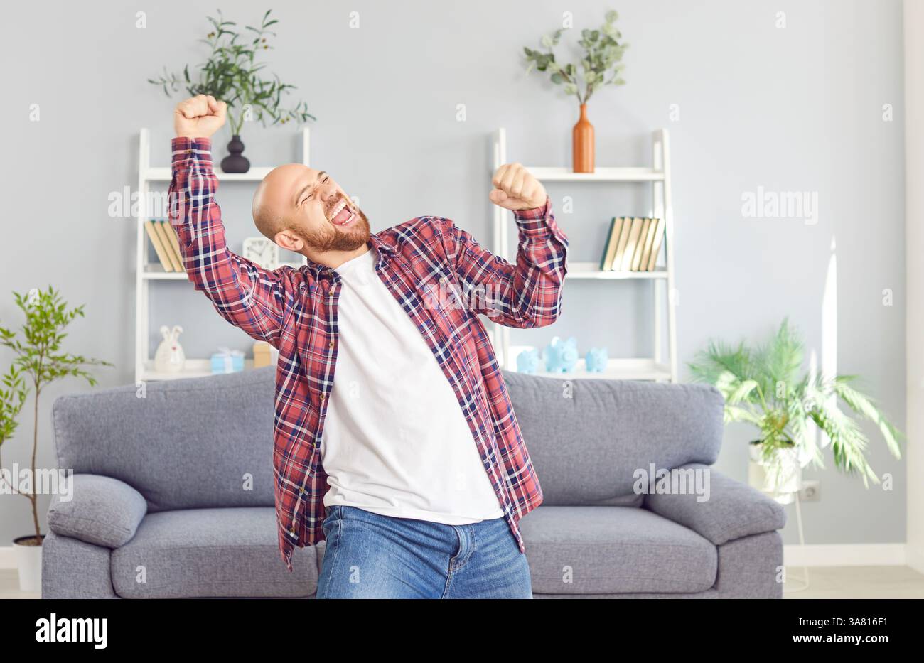 Joyful man celebrating victory hi-res stock photography and images - Alamy