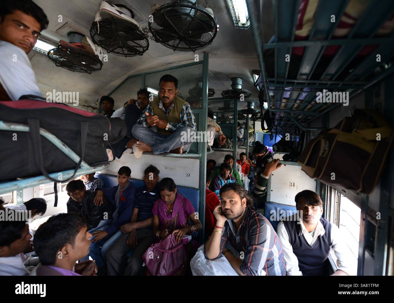 NEW DELHI, INDIA - FEBRUARY 26: Passengers travel in a crowded coach in ...