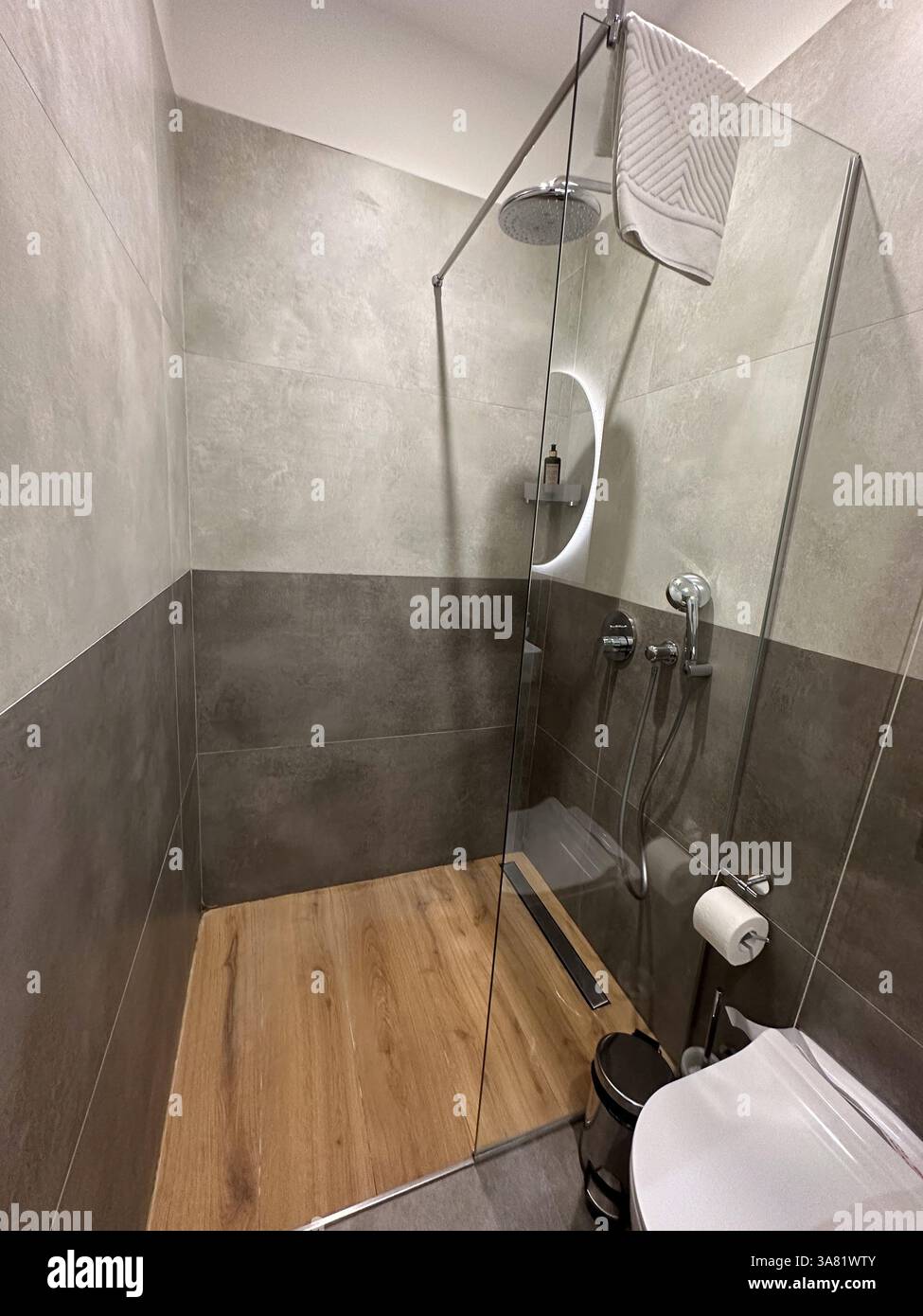 Compact walk-in shower in stylish urban bathroom with modern fixtures ...