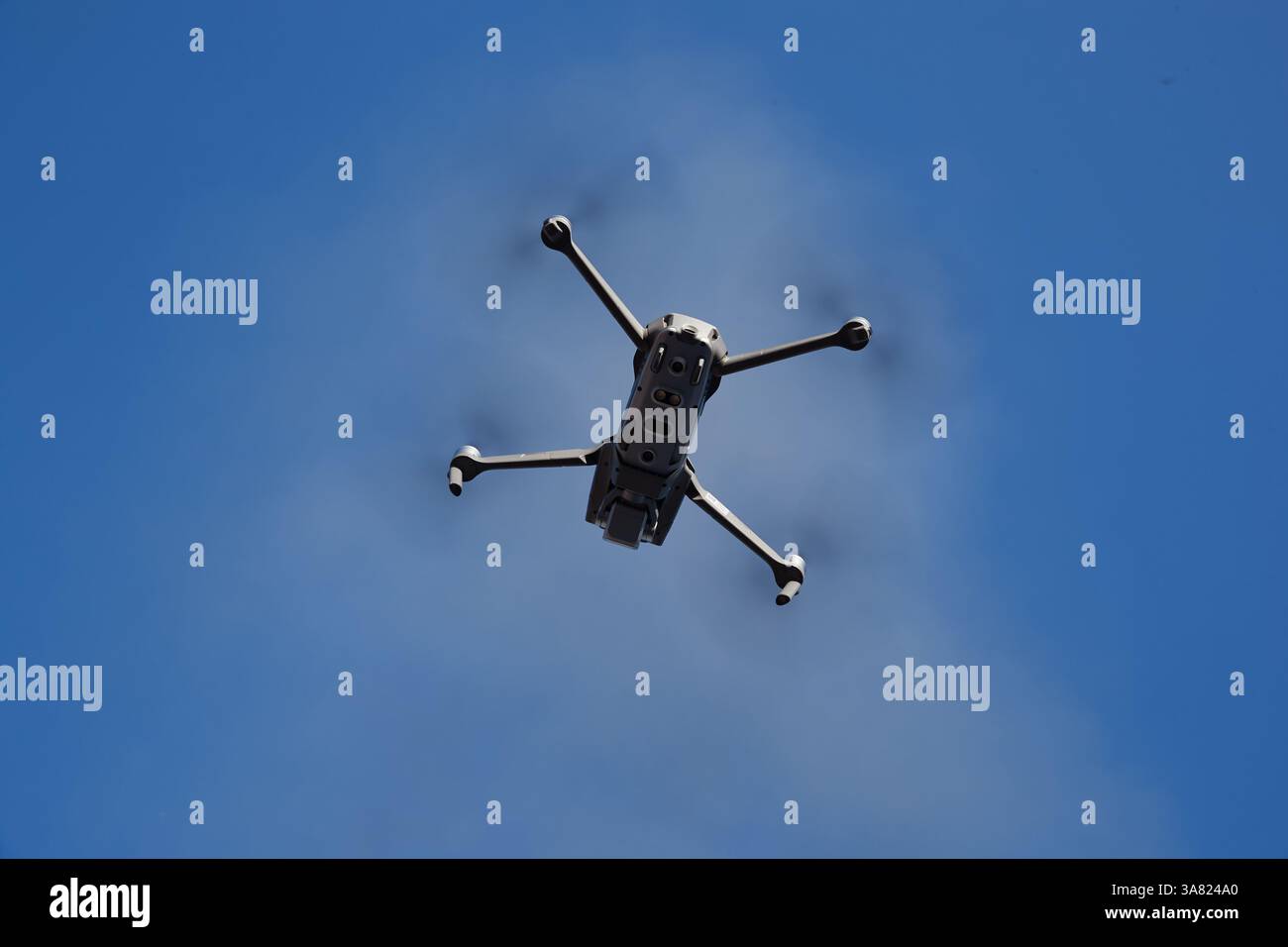Flying Drone Against Blue Sky Stock Photo - Alamy