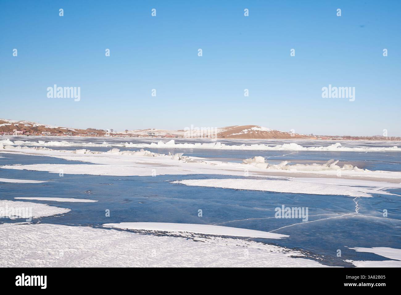 Frozen Lake with Mountain Range and Village Stock Photo - Alamy