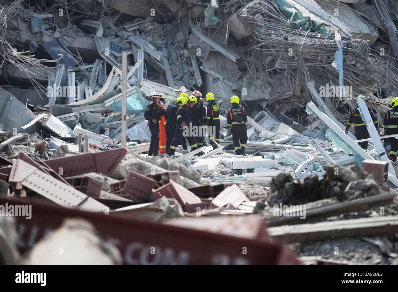 Rescuers work at the site of a high-rise building under construction ...
