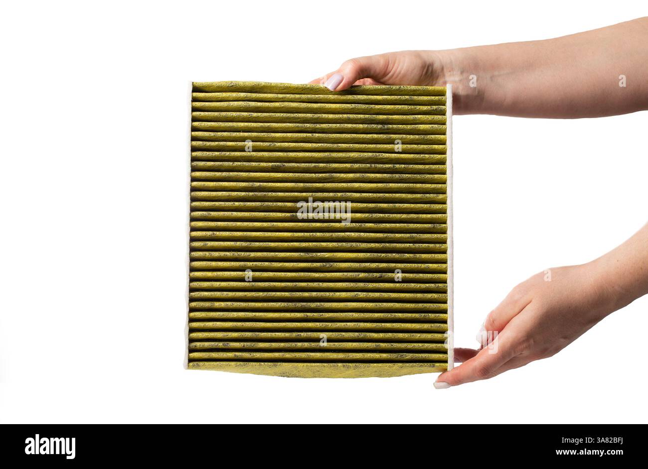 In hands is a modern yellow filter for cleaning air from the car ...