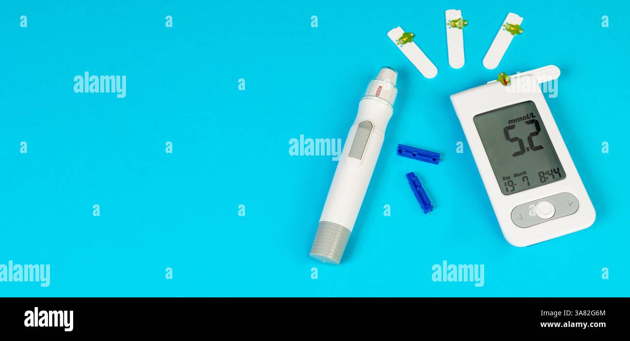 Blood glucose meter and insulin pen placed on a blue background with ...