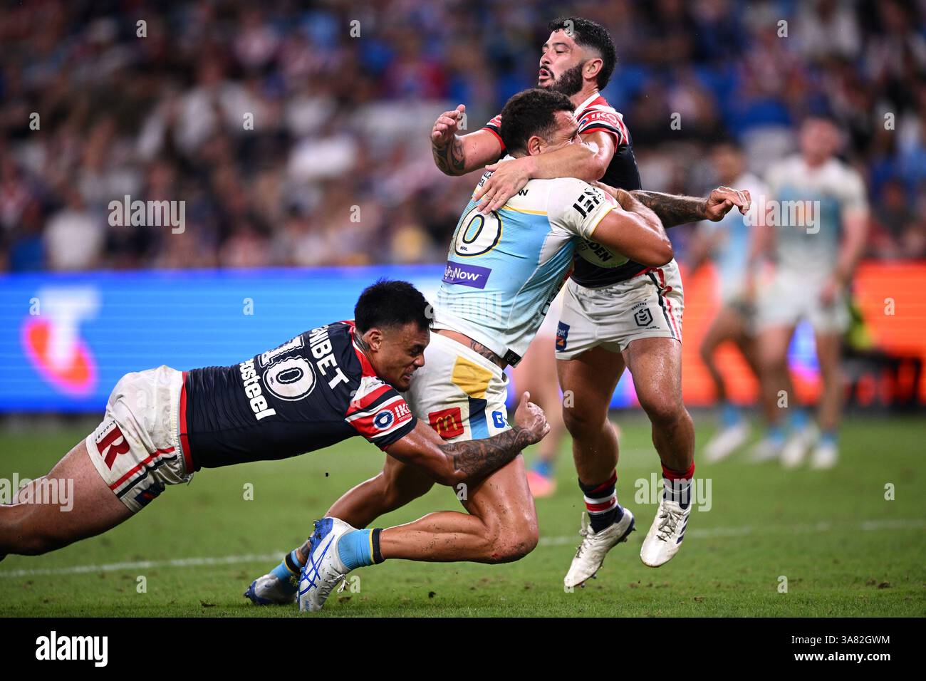 Reagan Campbell-Gillard of the Titans is tackled by Spencer Leniu (left ...