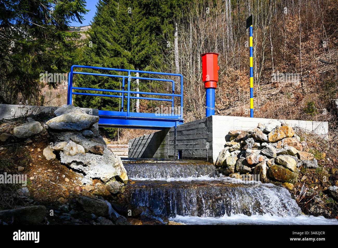 Water flowing through small dam of hydroelectric power plant in a ...