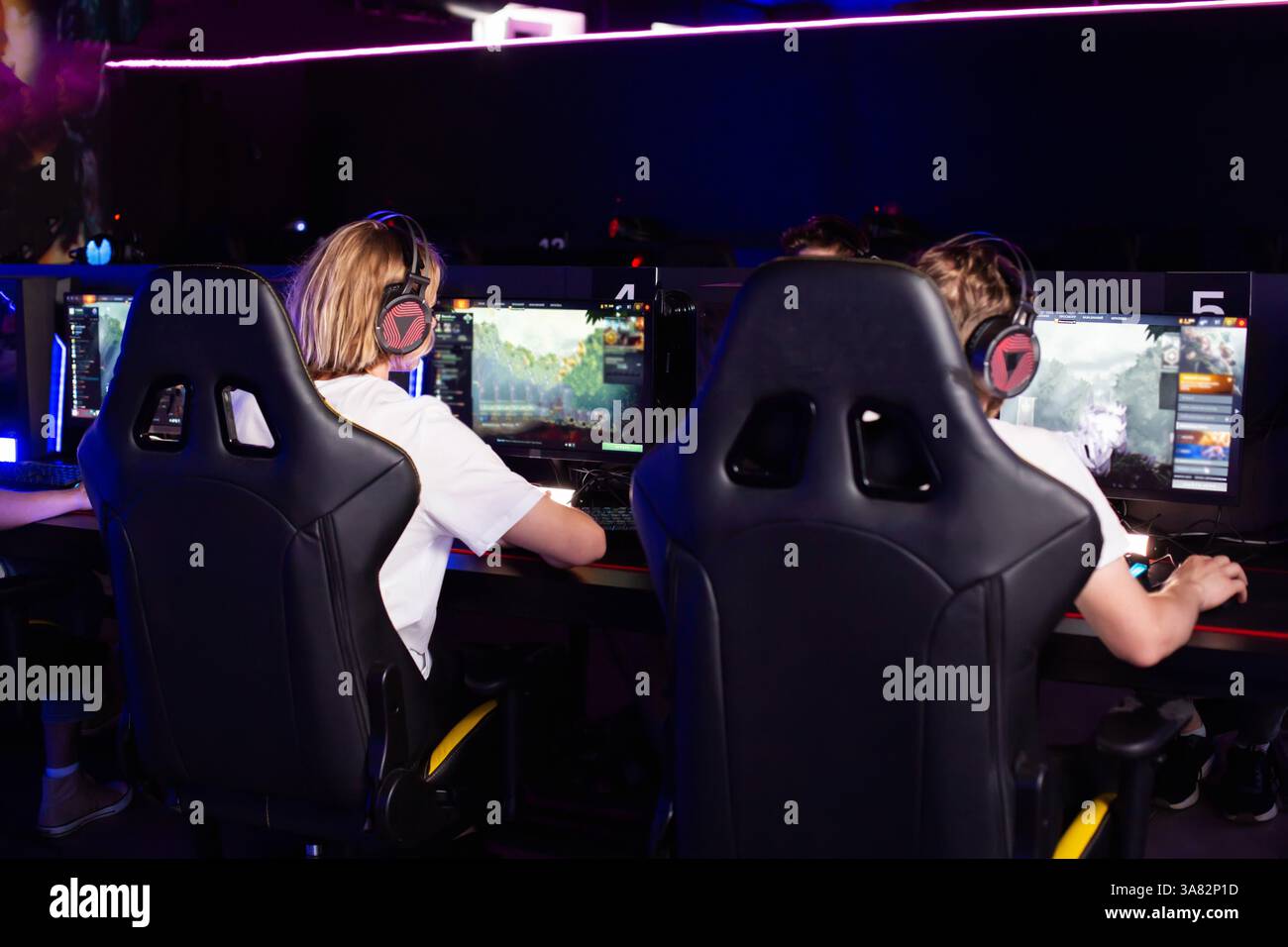 Guys are playing multiplayer online battle arena strategy game. Male ...