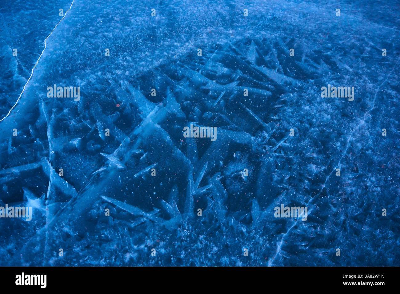 Ice Cracks and Patterns on Frozen Lake Stock Photo - Alamy