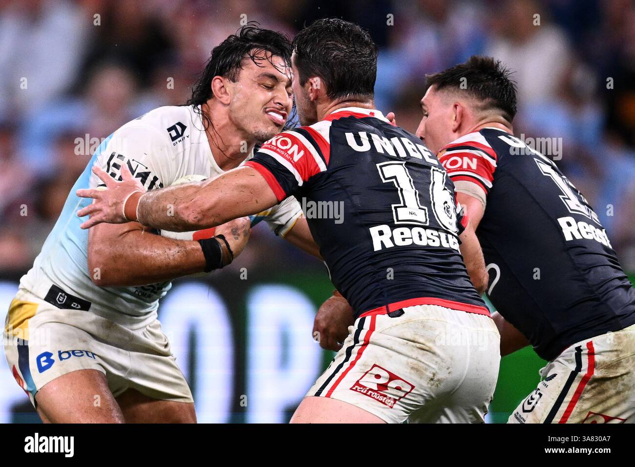 Tino Fa’asuamaleaui of the Titans is tackled by Nat Butcher (left) and ...