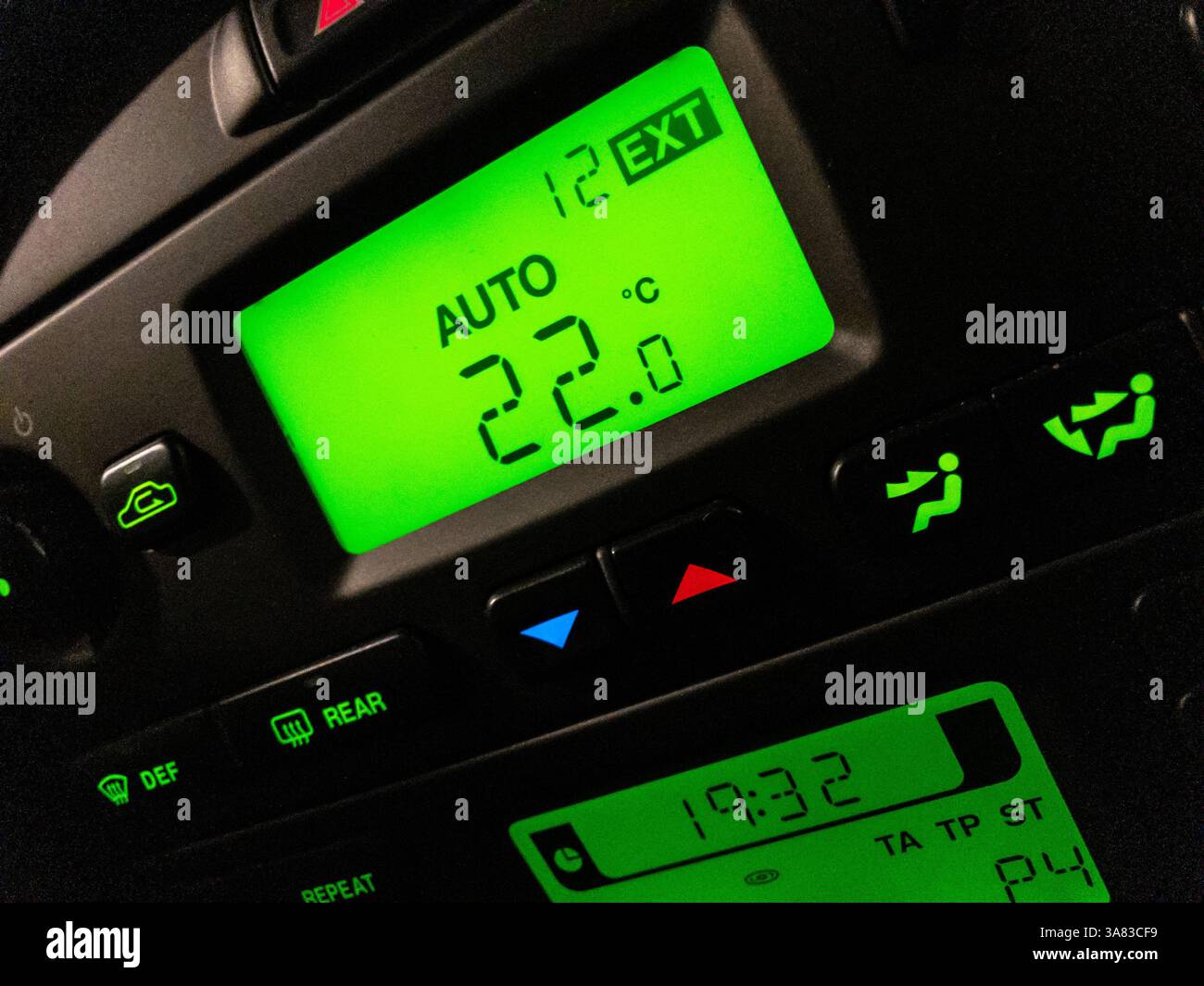 Green LCD air conditioning display on a car dashboard, showing an ...
