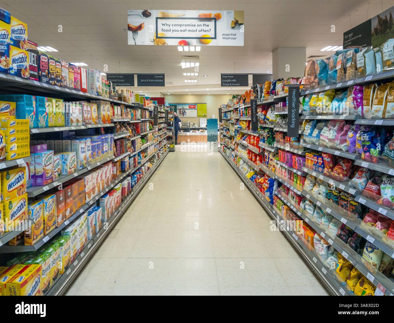 Looking down a supermarket aisle in Waitrose, with cereals, jams, and ...