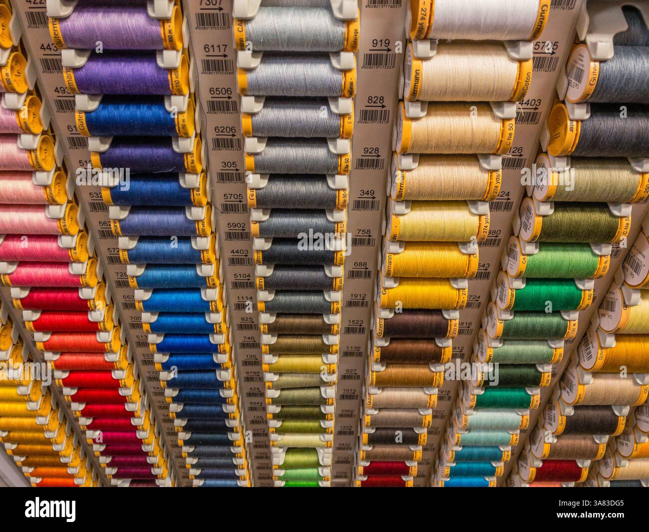 Reels of colourful Gütermann cotton thread neatly arranged and sorted ...