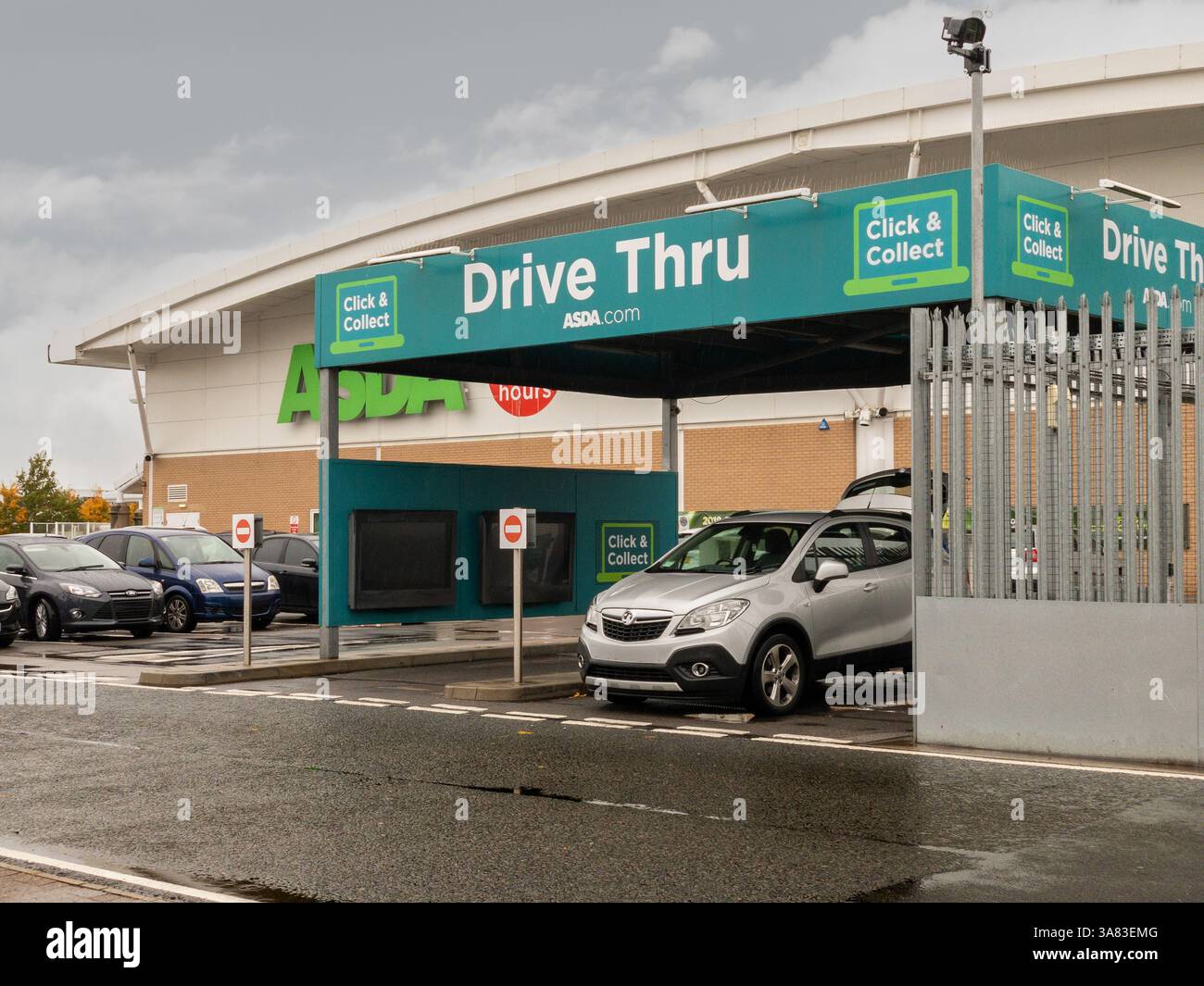Drive-thru click & collect canopy at an Asda supermarket, set against a ...