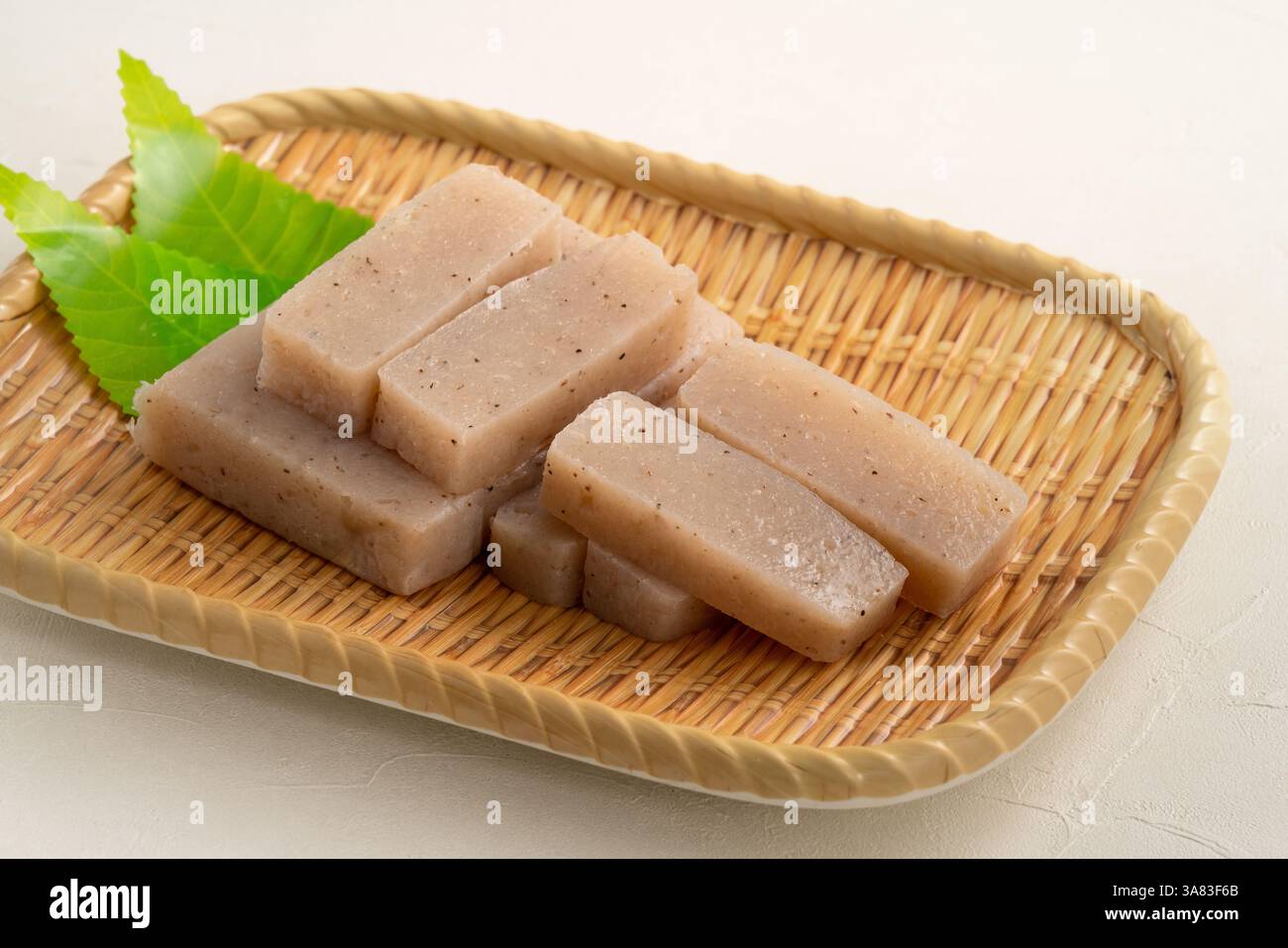 Raw konjac in square shape in a plate on white table background, also ...