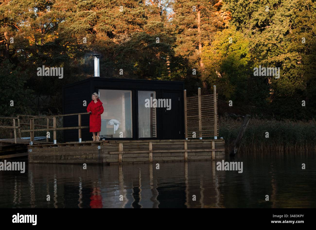 woman standing by a floating sauna in the Swedish archipelago Stock ...