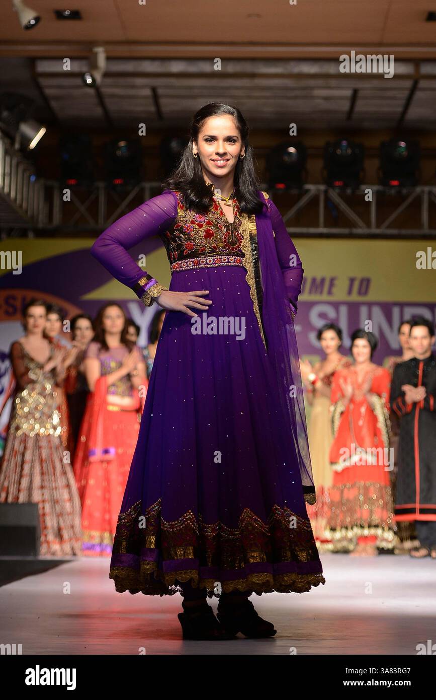 NEW DELHI, INDIA - APRIL 22: Saina Nehwal displays a creation by Charu ...