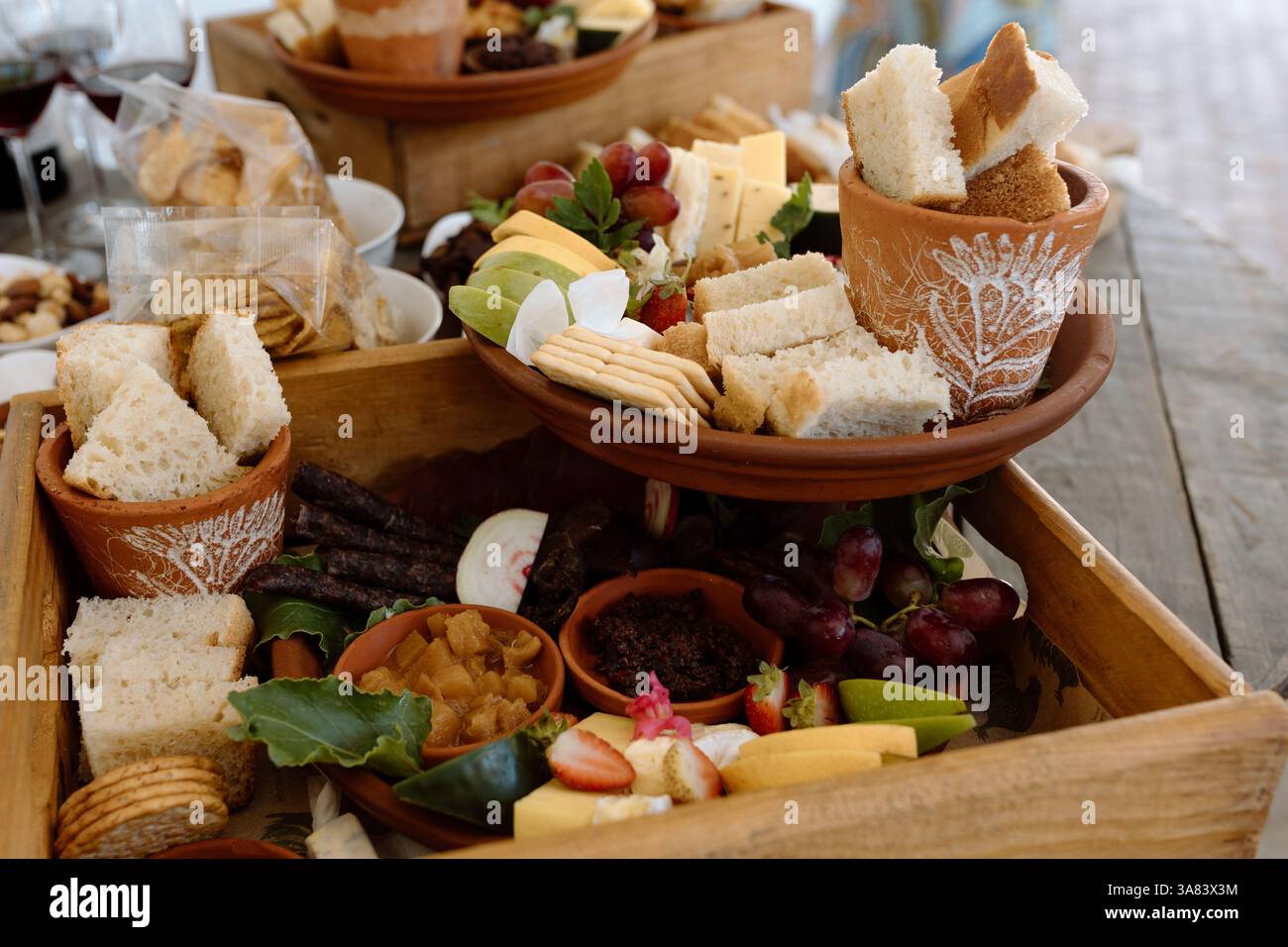 Snack platter board with meat, cheese, fruit, preserves and breads ...