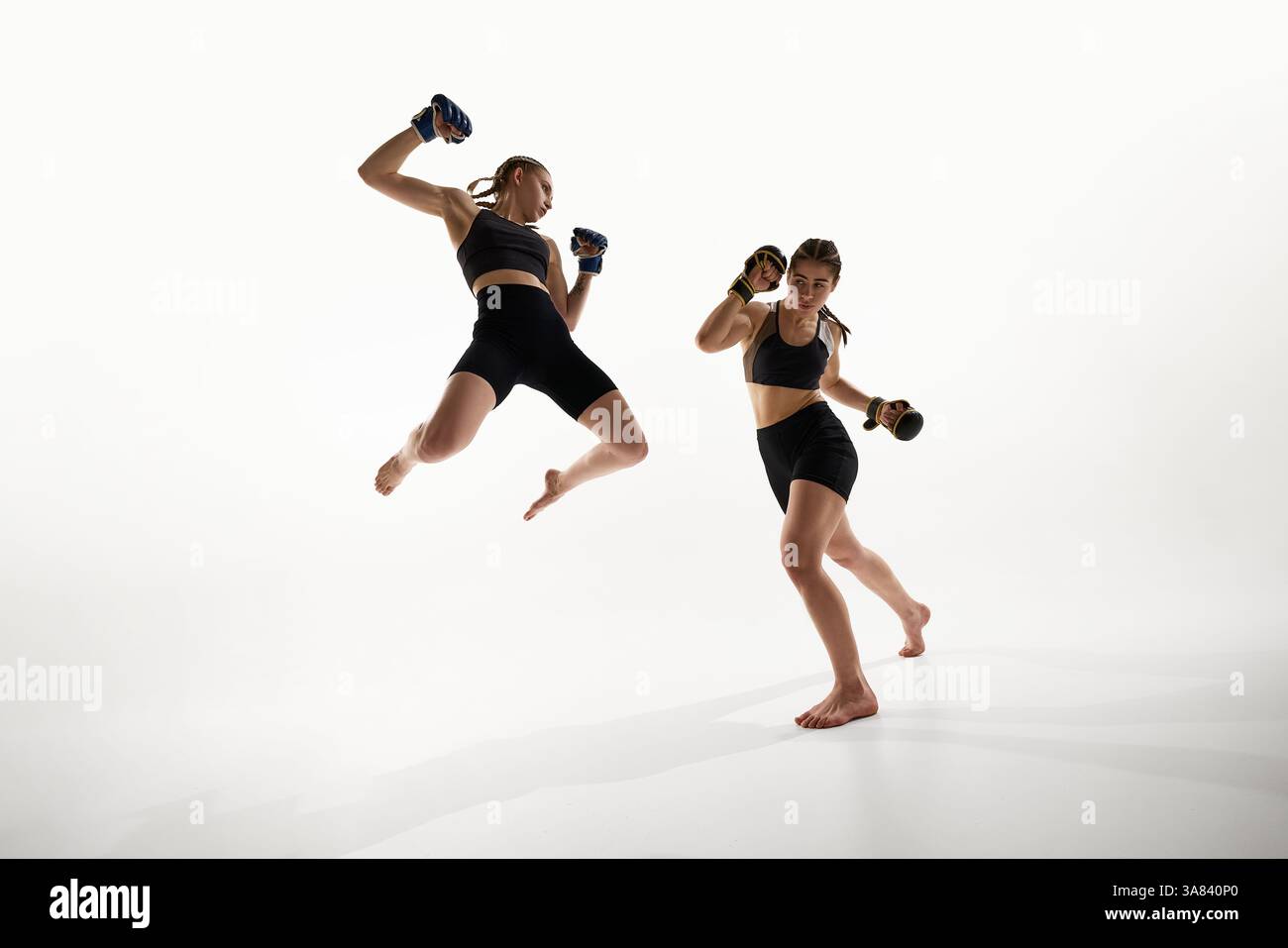Dynamic mid-air attack moment captured between two female fighters in ...