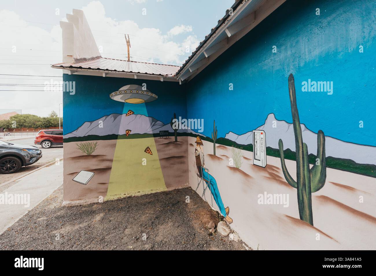 Desert-themed UFO mural with pizza outside Para Llevar, Marfa Stock ...