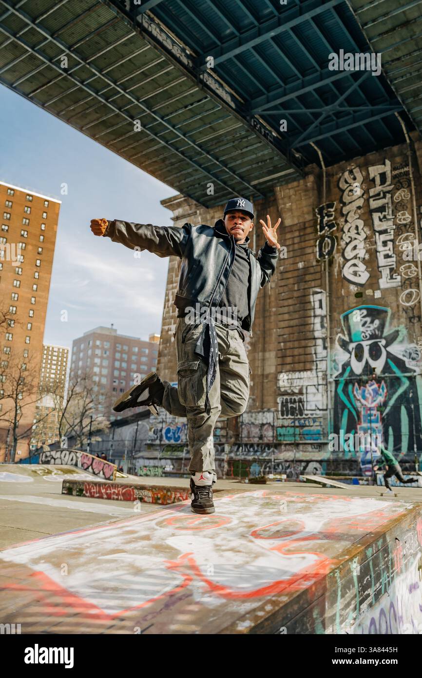 Street dancer strikes dynamic pose on urban graffiti platform Stock ...