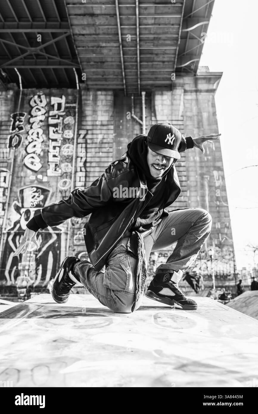 Dancer poses low with dynamic motion in monochrome street scene Stock ...
