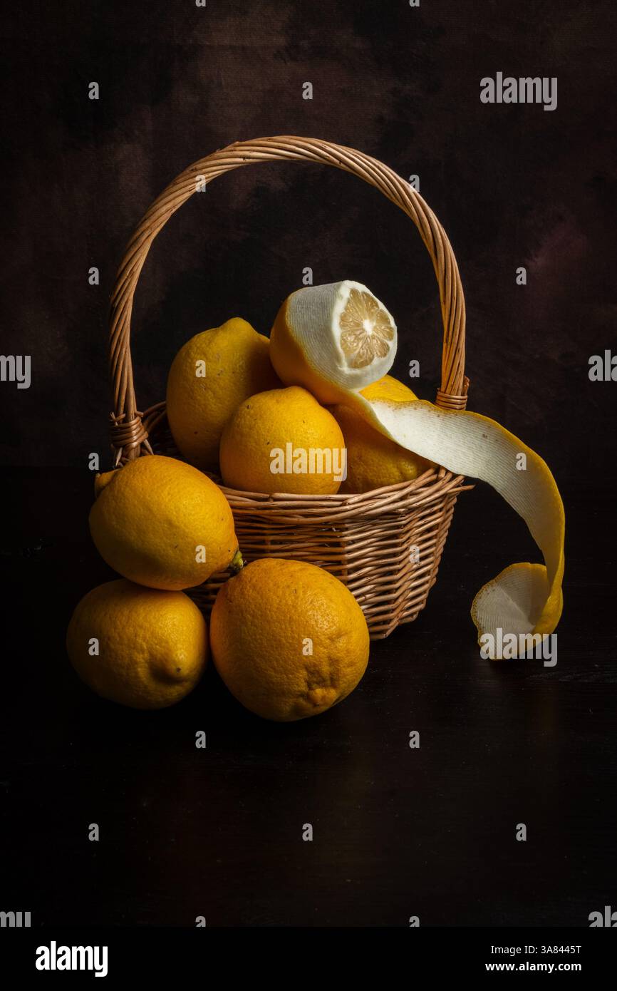 Peeled lemon in a basket with more lemons Stock Photo - Alamy