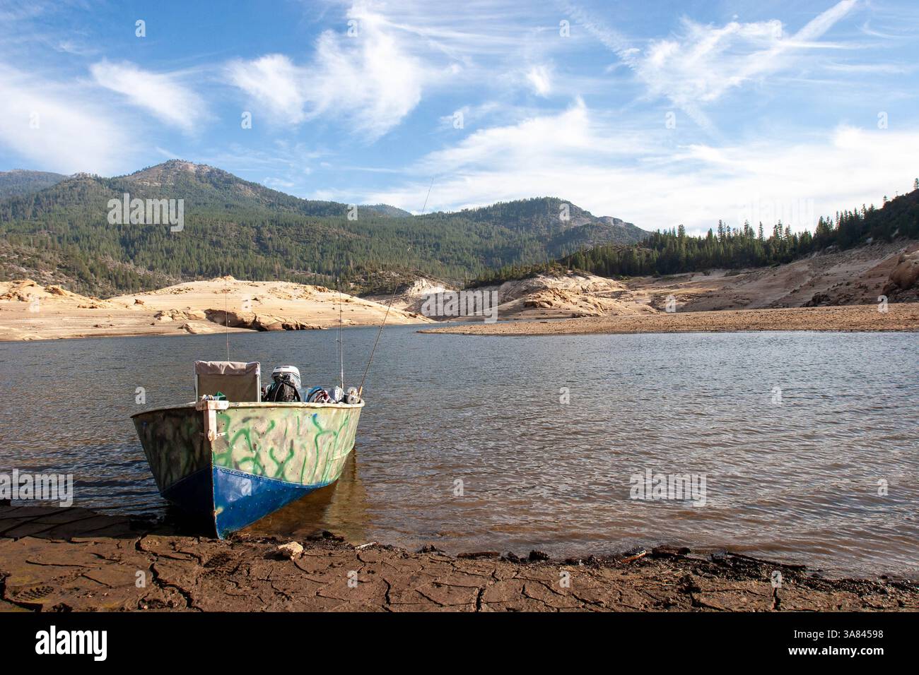 Fishing boat on cracked shoreline at Mammoth Pool Reservoir, CA Stock ...