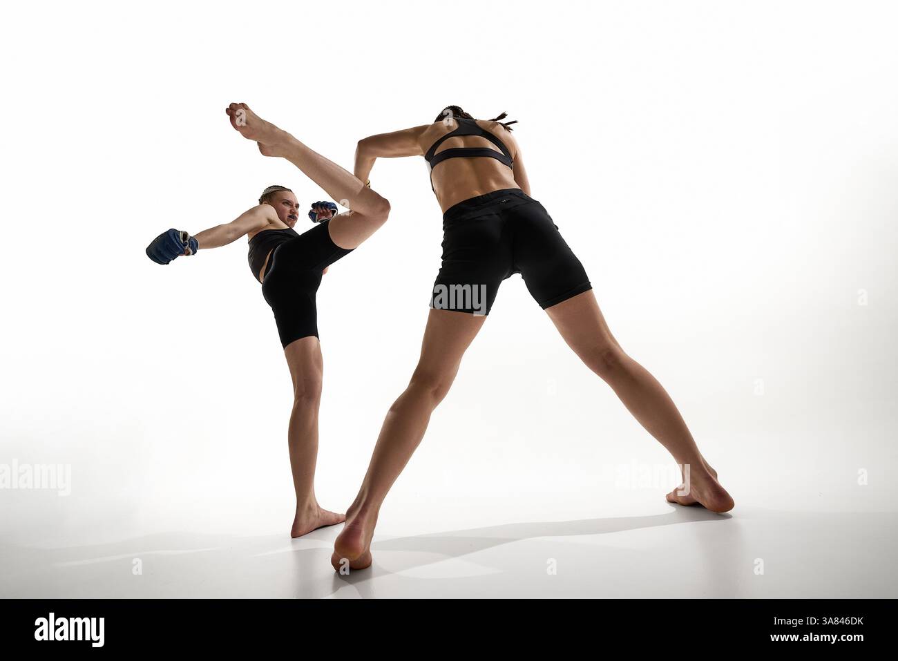 Fighter blocking kick from opponent, intense training moment captured ...