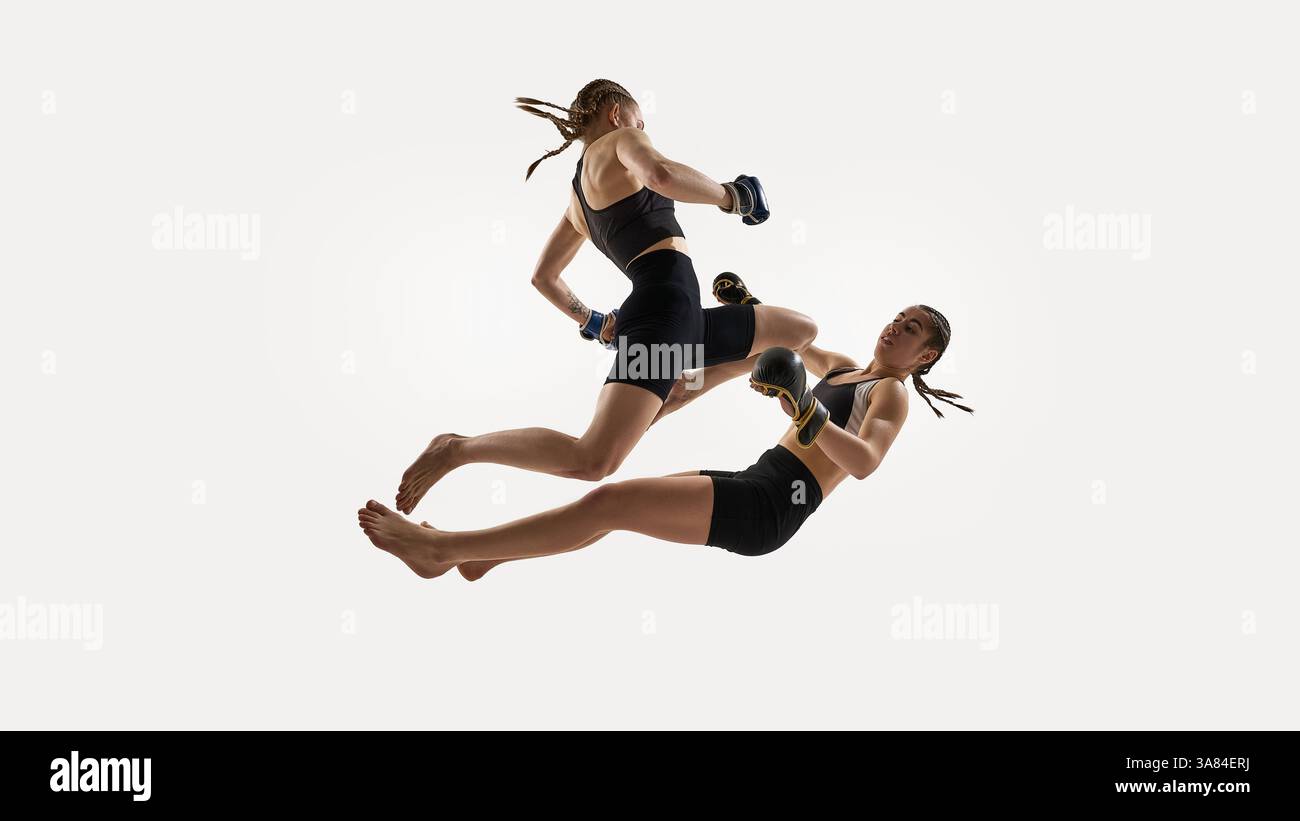 Mid-air clash of female athletes wearing boxing gloves, captured in ...