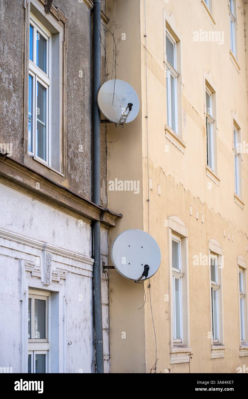 View of two satellite dishes installed on the wall of a residential ...