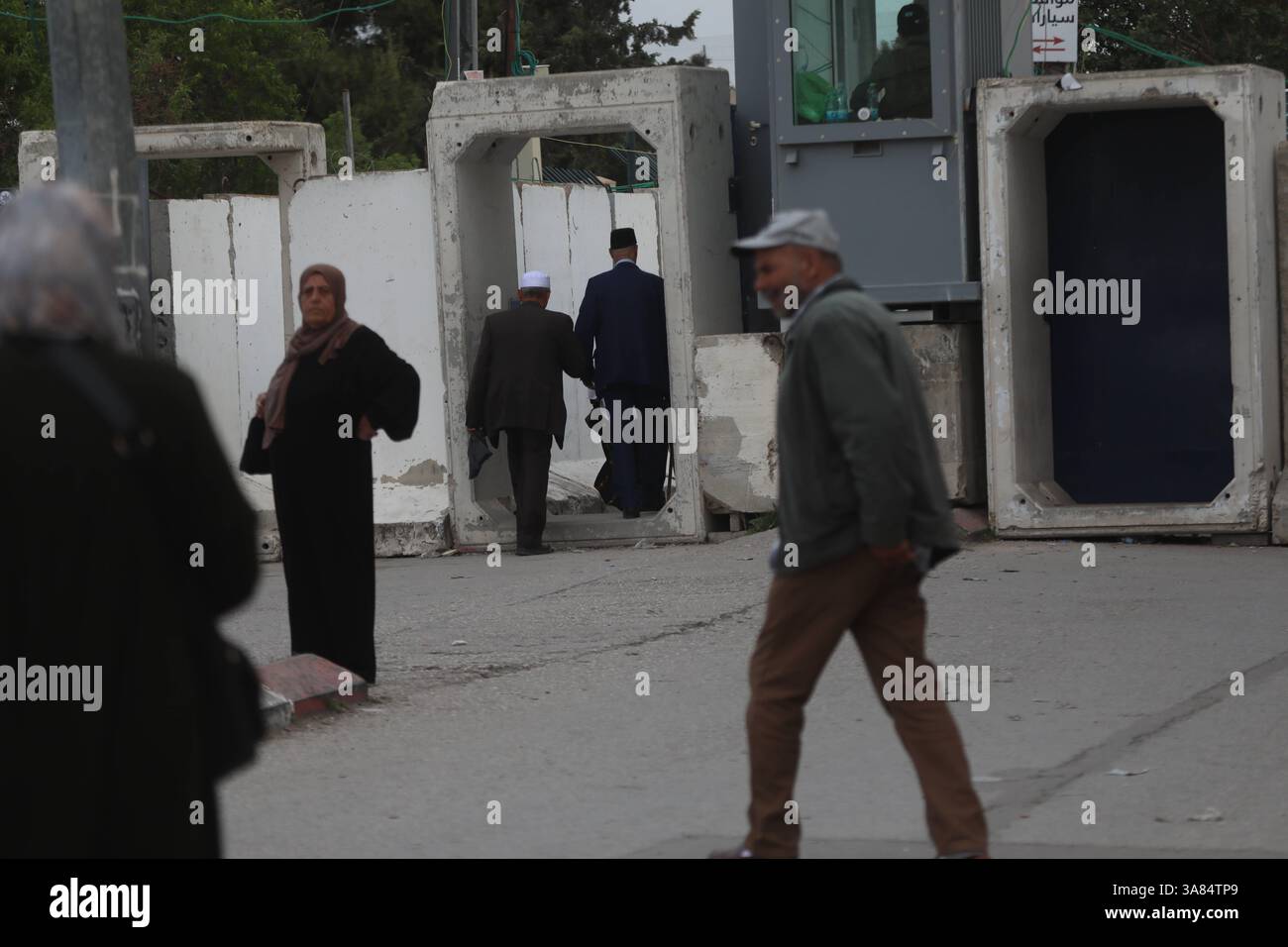 Palestinians cross an Israeli army checkpoint in Bethlehem, in the ...