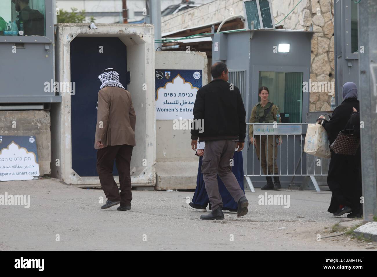 Palestinians cross an Israeli army checkpoint in Bethlehem, in the ...