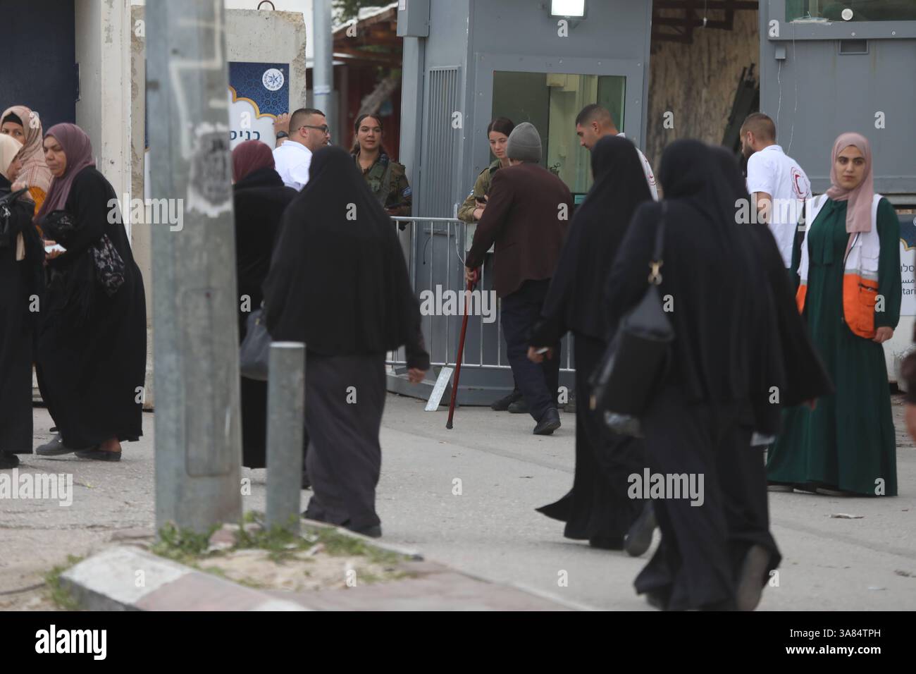Palestinians cross an Israeli army checkpoint in Bethlehem, in the ...