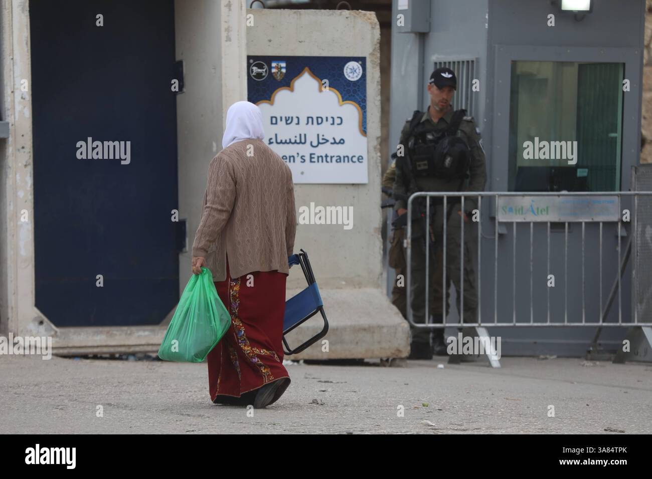 Palestinians cross an Israeli army checkpoint in Bethlehem, in the ...