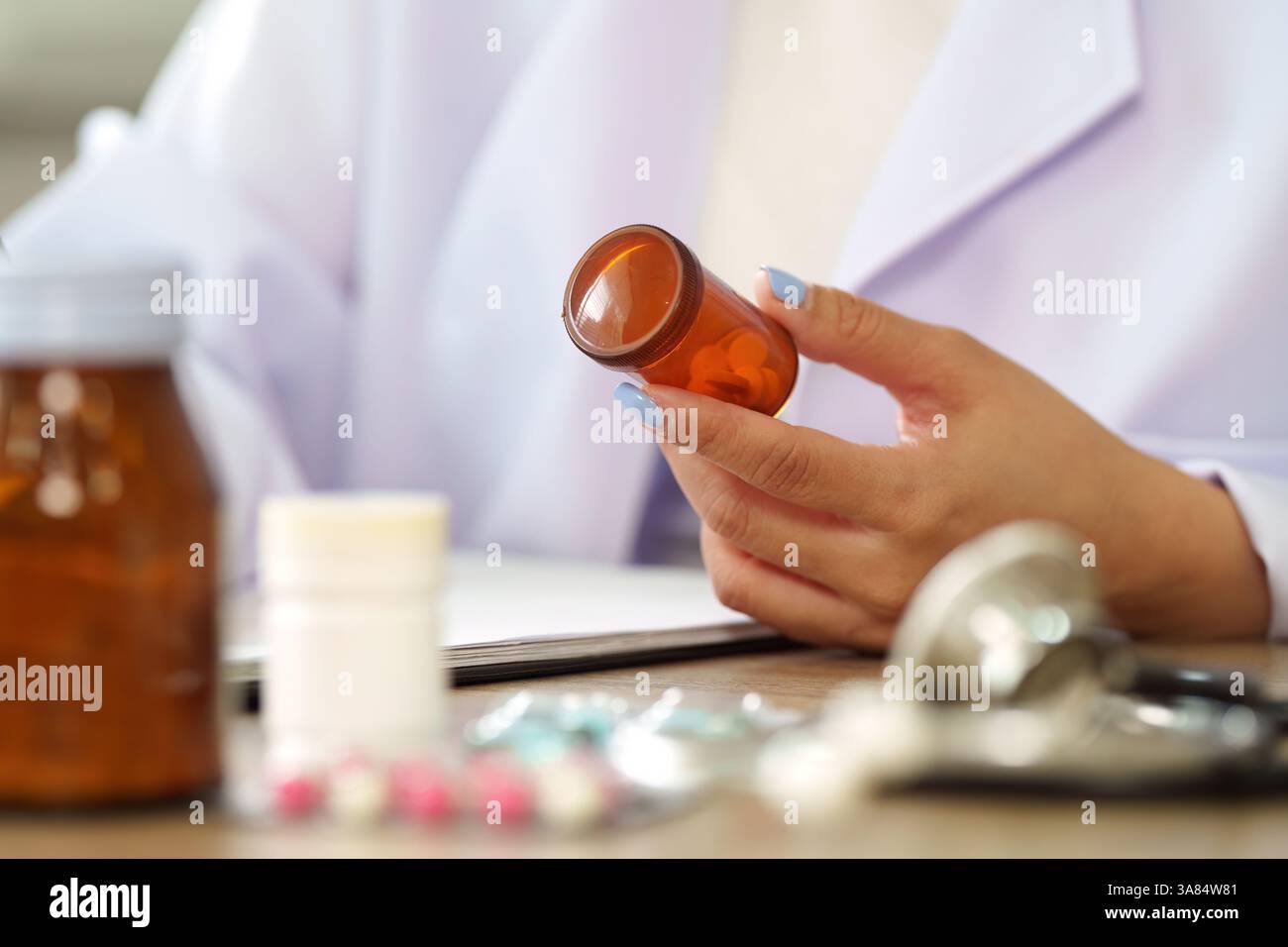 Medication and Health Awareness. A doctor examines a medication bottle ...