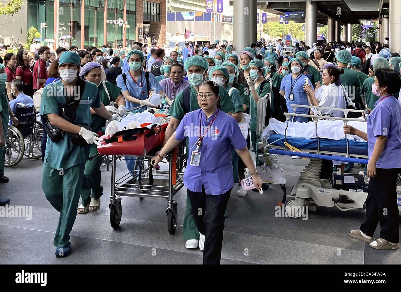 Medical personnel and patients evacuate from hospital buildings in ...