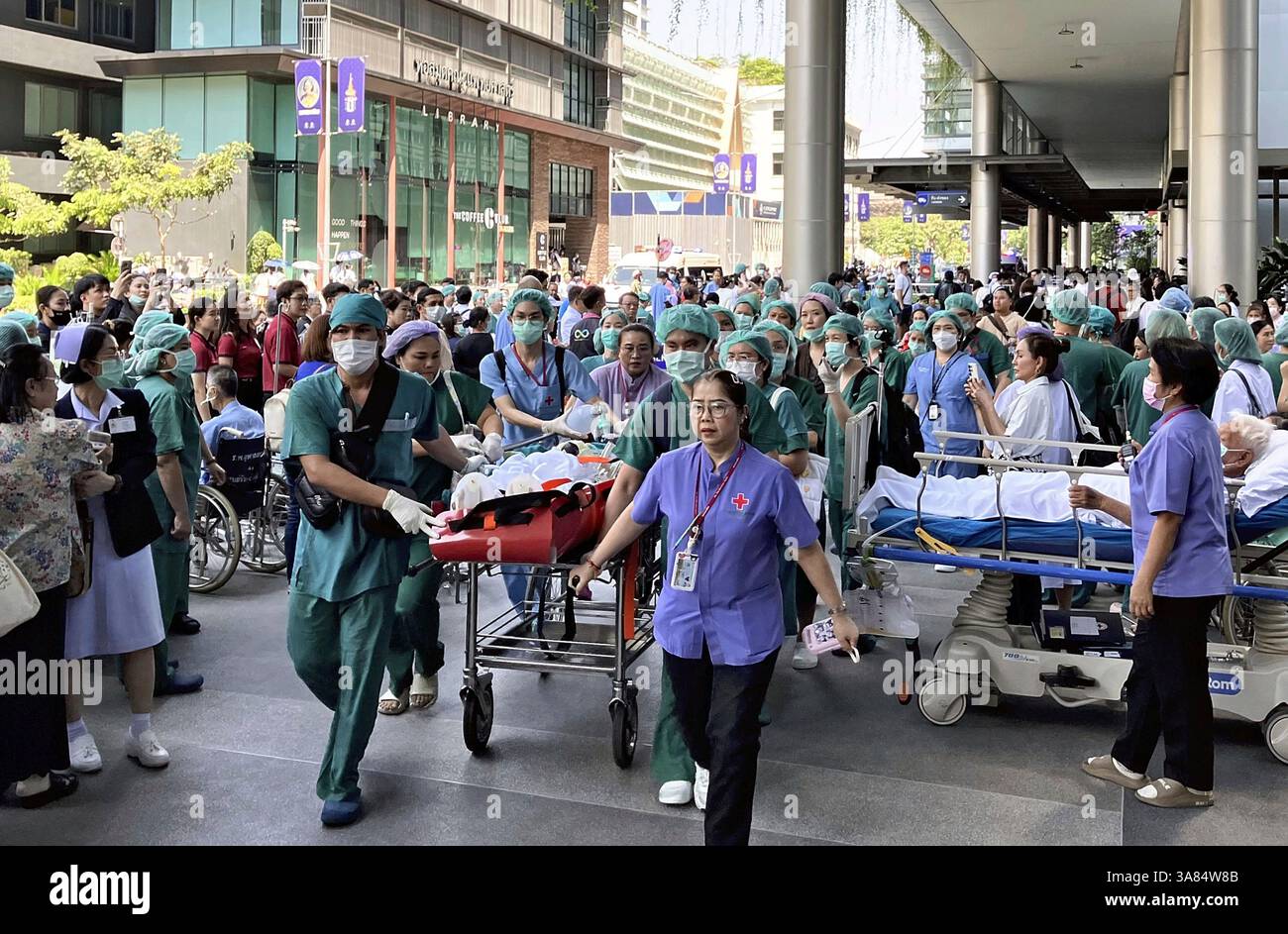Medical personnel and patients evacuate from hospital buildings in ...