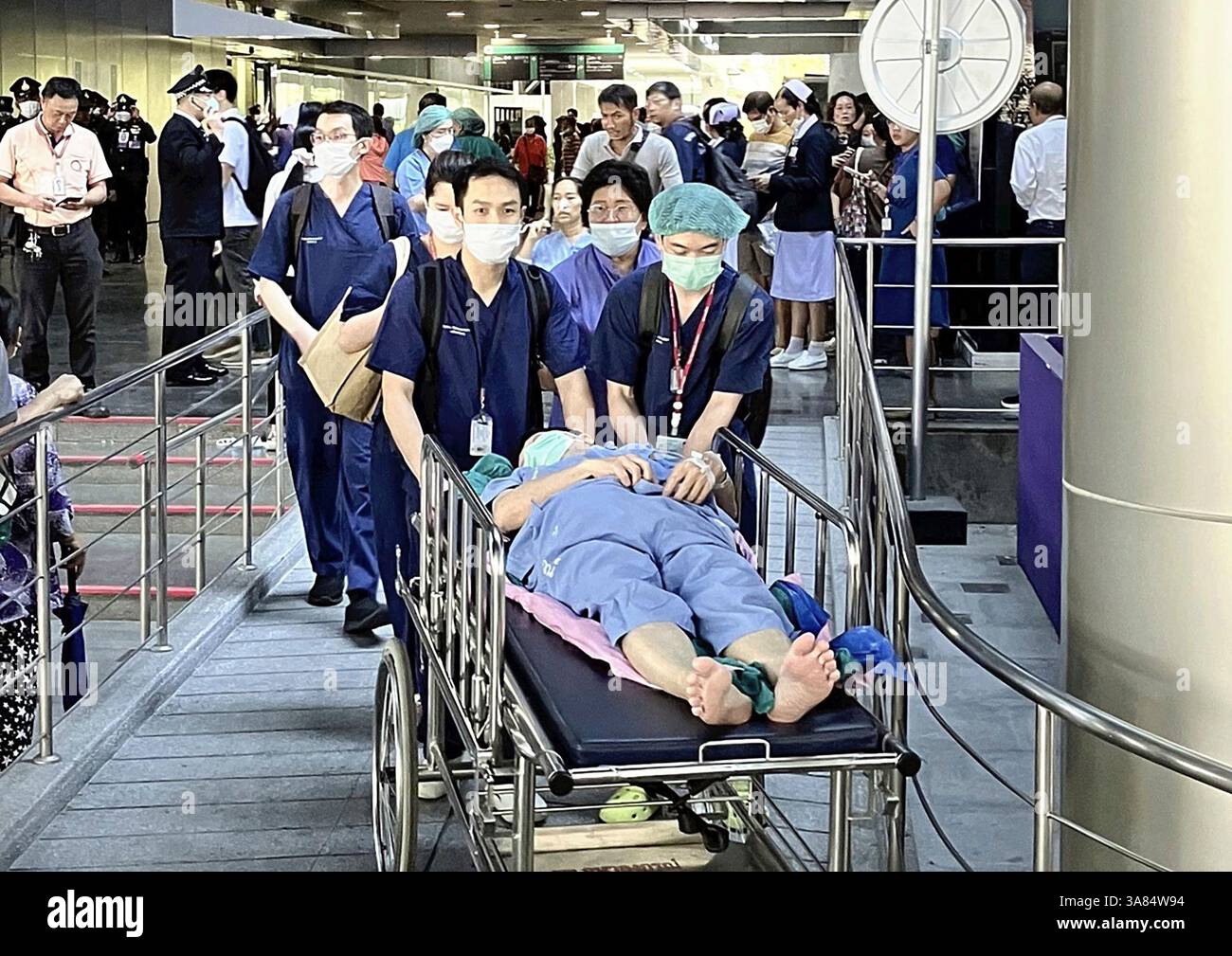 Medical personnel and patients evacuate from hospital buildings in ...