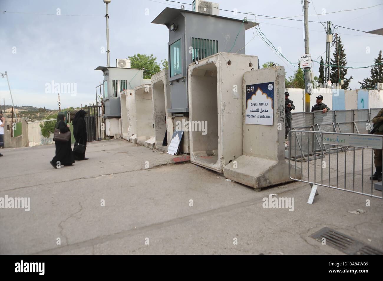 Palestinians cross an Israeli army checkpoint in Bethlehem, in the ...