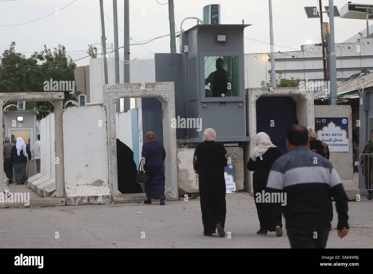 Palestinians cross an Israeli army checkpoint in Bethlehem, in the ...