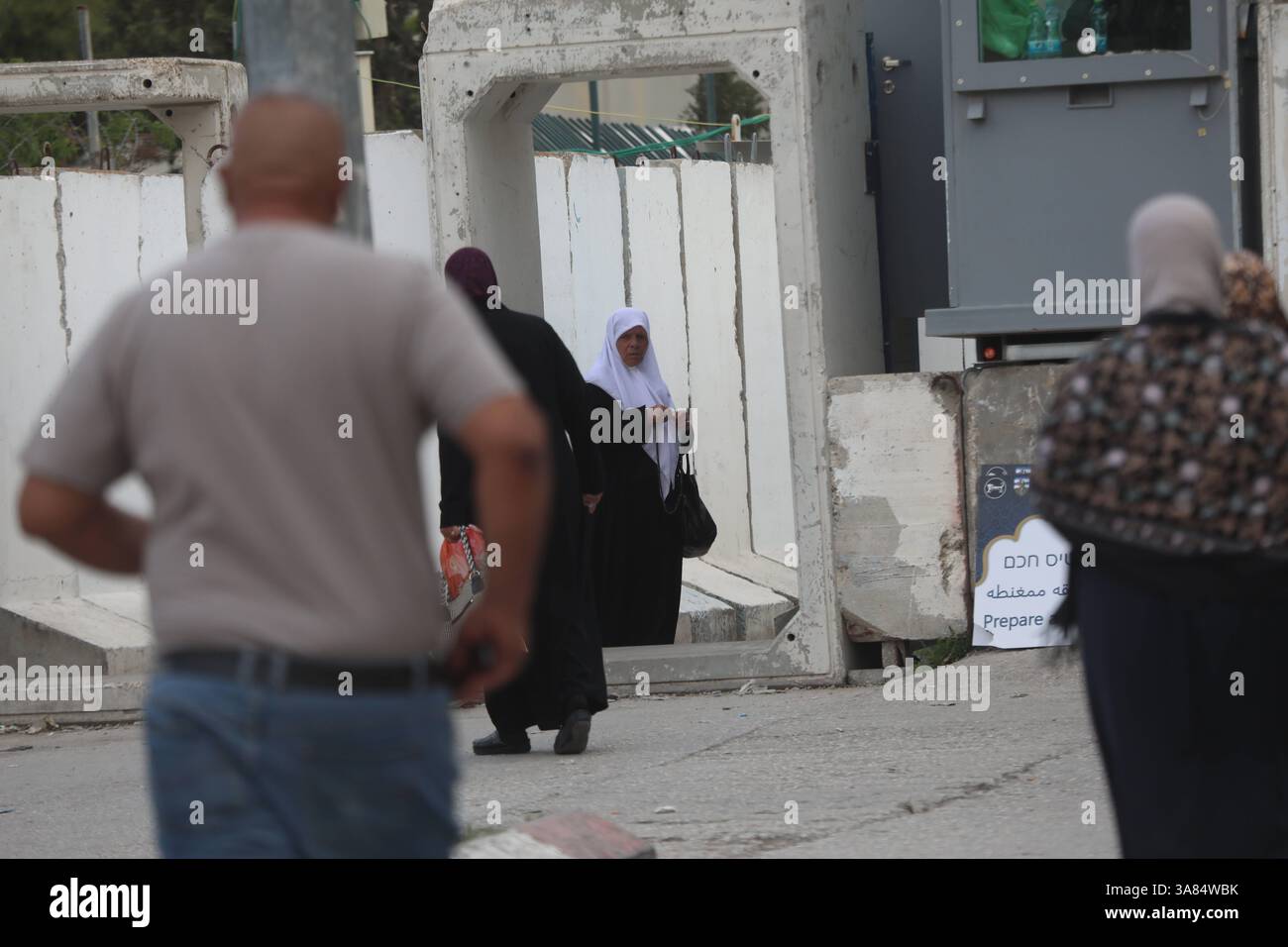 Palestinians cross an Israeli army checkpoint in Bethlehem, in the ...