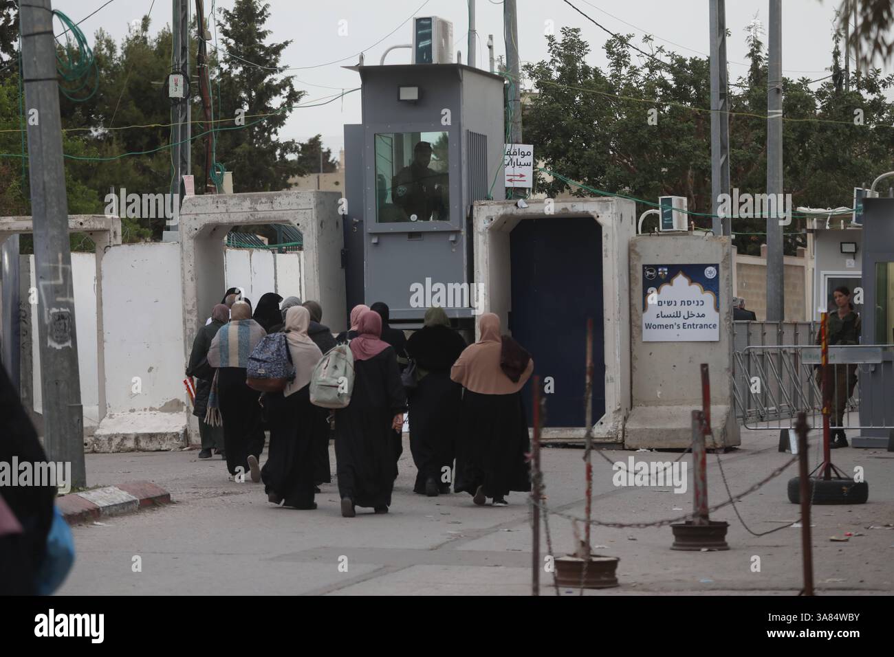 Palestinians cross an Israeli army checkpoint in Bethlehem, in the ...